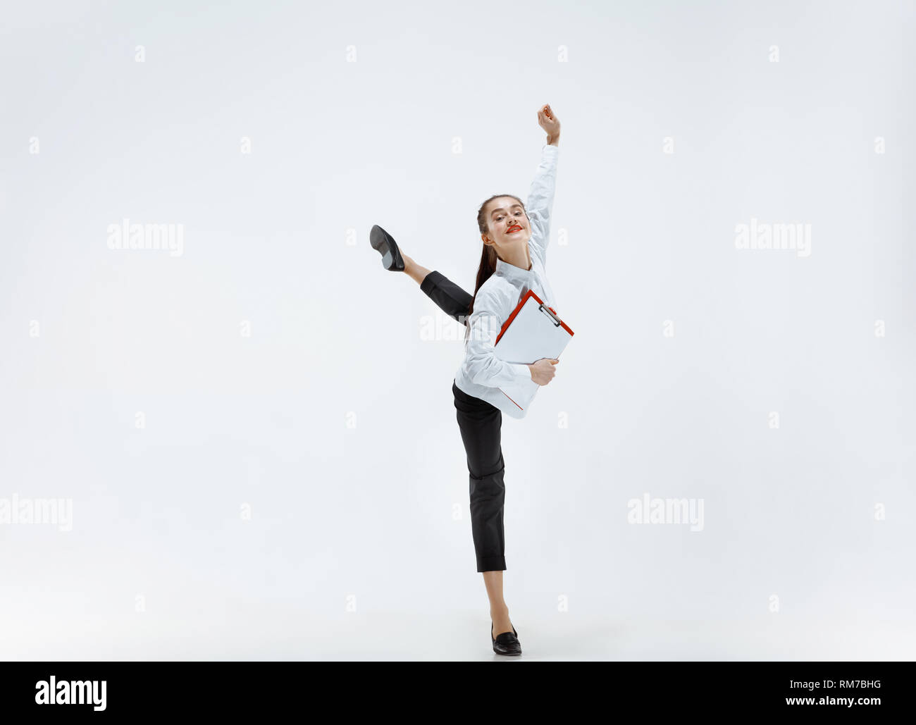 Happy businesswoman dancing and smiling in motion isolated on white ...