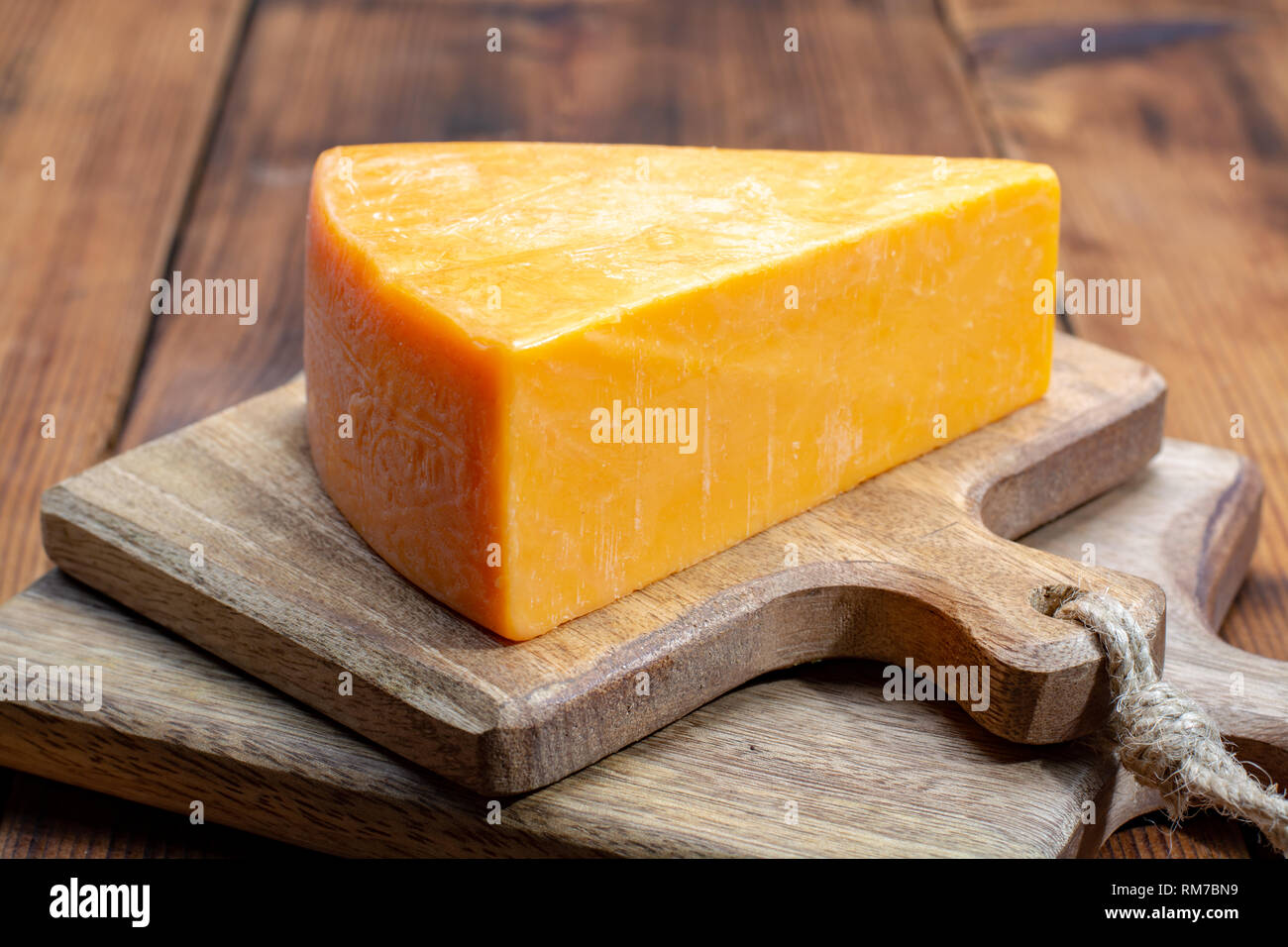 Piece of bright yellow hard cheese cheddar, originating in the English ...