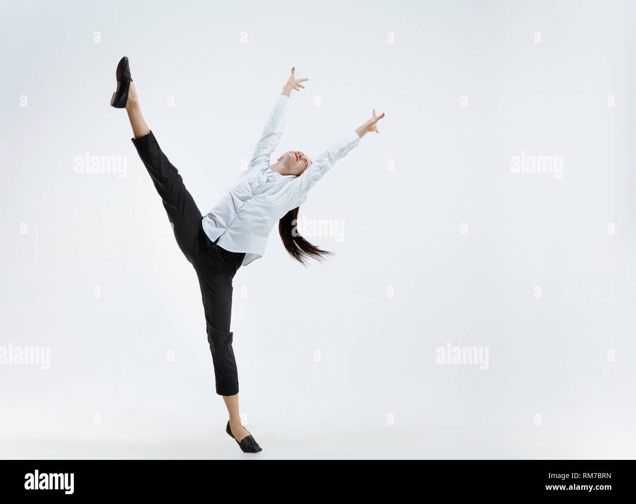 Happy businesswoman dancing and smiling in motion isolated on white ...