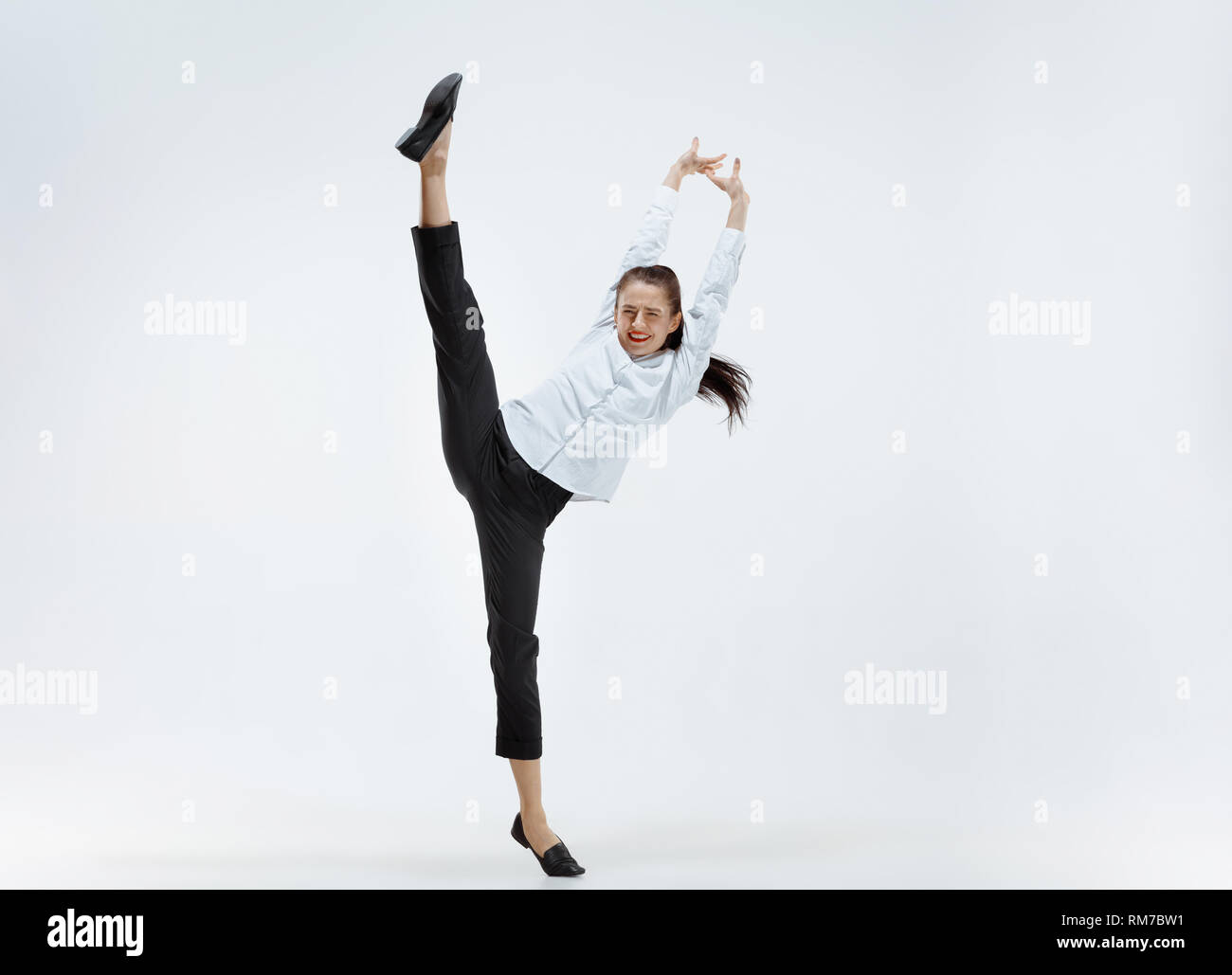 Happy businesswoman dancing and smiling in motion isolated on white ...