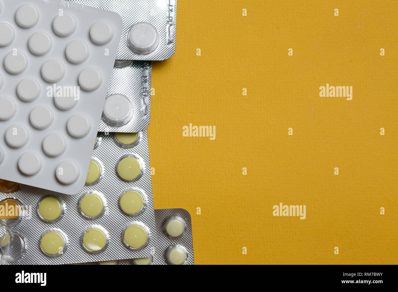 Medication round tablets arranged abstract on yellow color background ...
