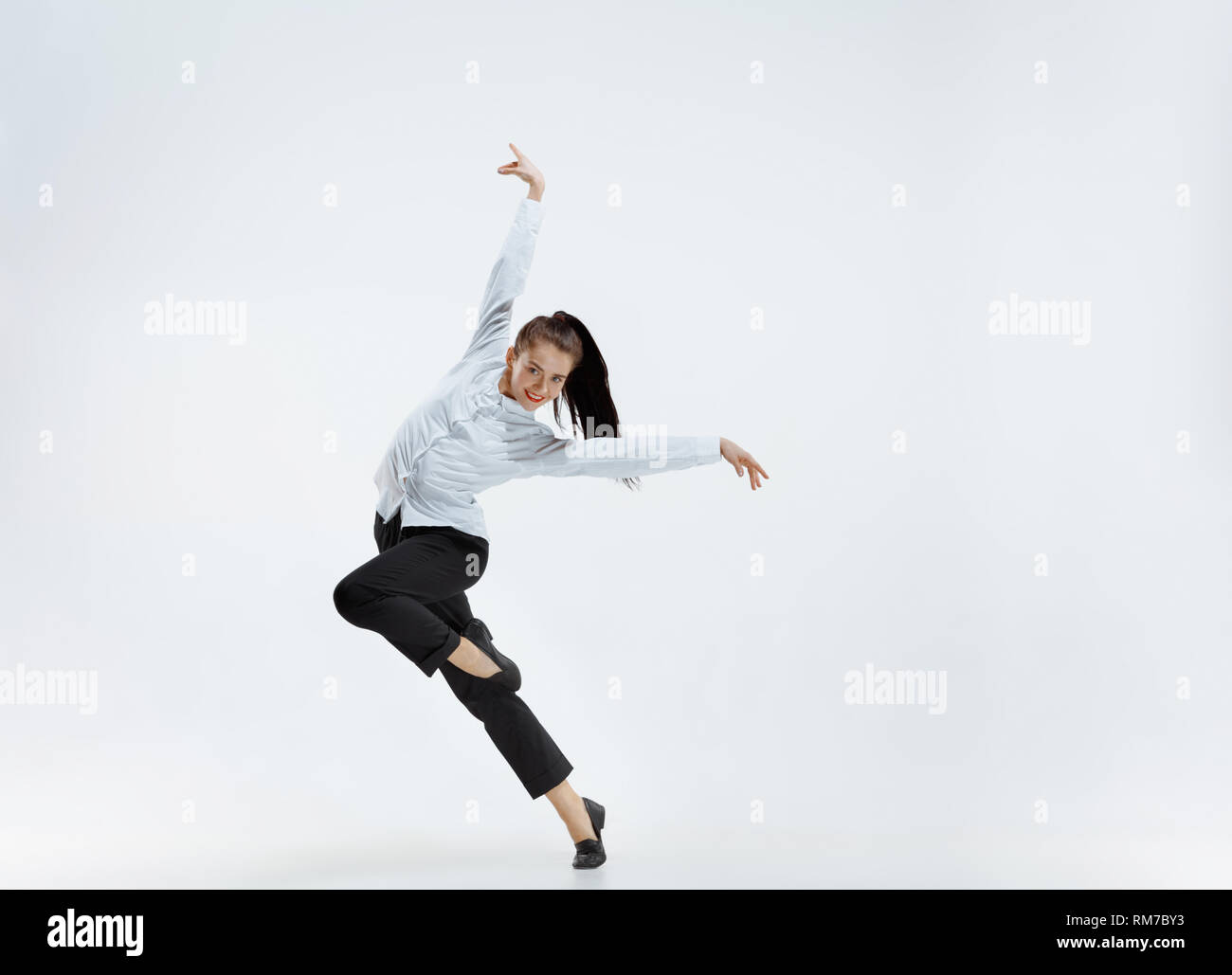 Happy businesswoman dancing and smiling in motion isolated on white ...