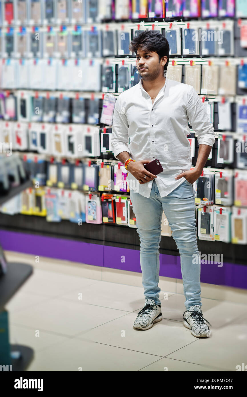 Indian man customer buyer at mobile phone store choose a case for his ...