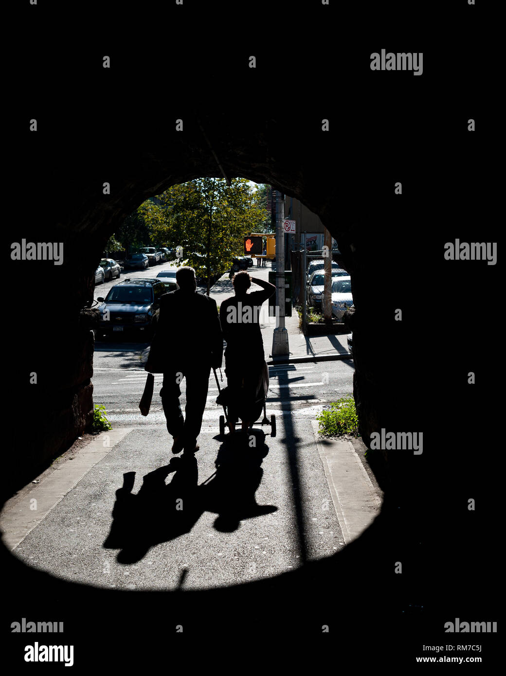 Arch archway tunnel shadow silhouette man woman female male push hi-res ...