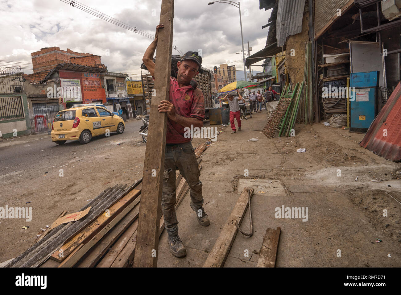 Medellin, Colombia - July 26, 2018: man lifting a wood plank in a ...
