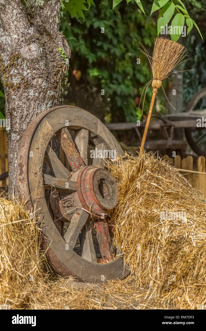 View of scenery in medieval fair, with traditional wagon wheel leaning ...