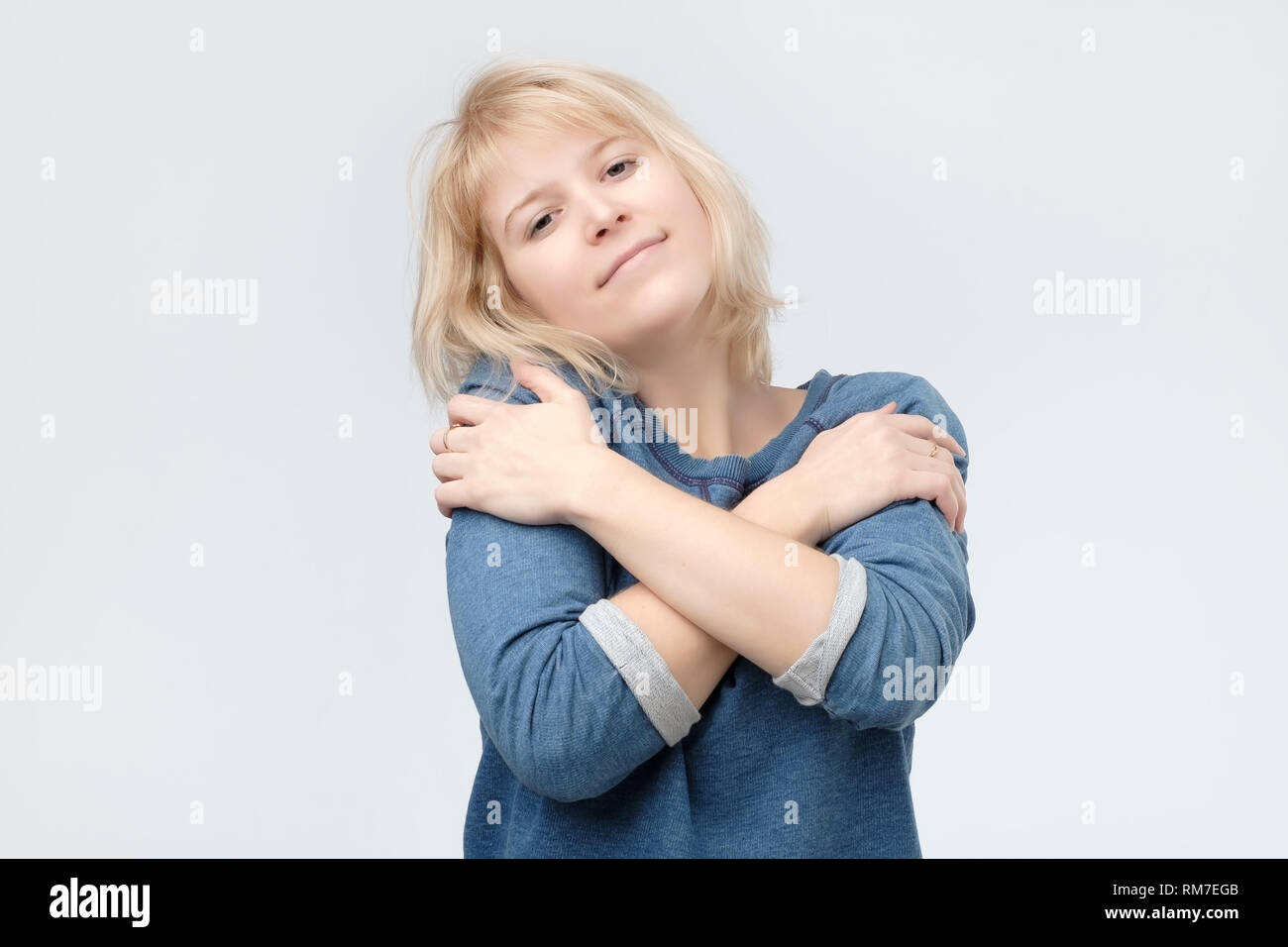 Confident smiling teenager holding hugging herself. Love yourself ...
