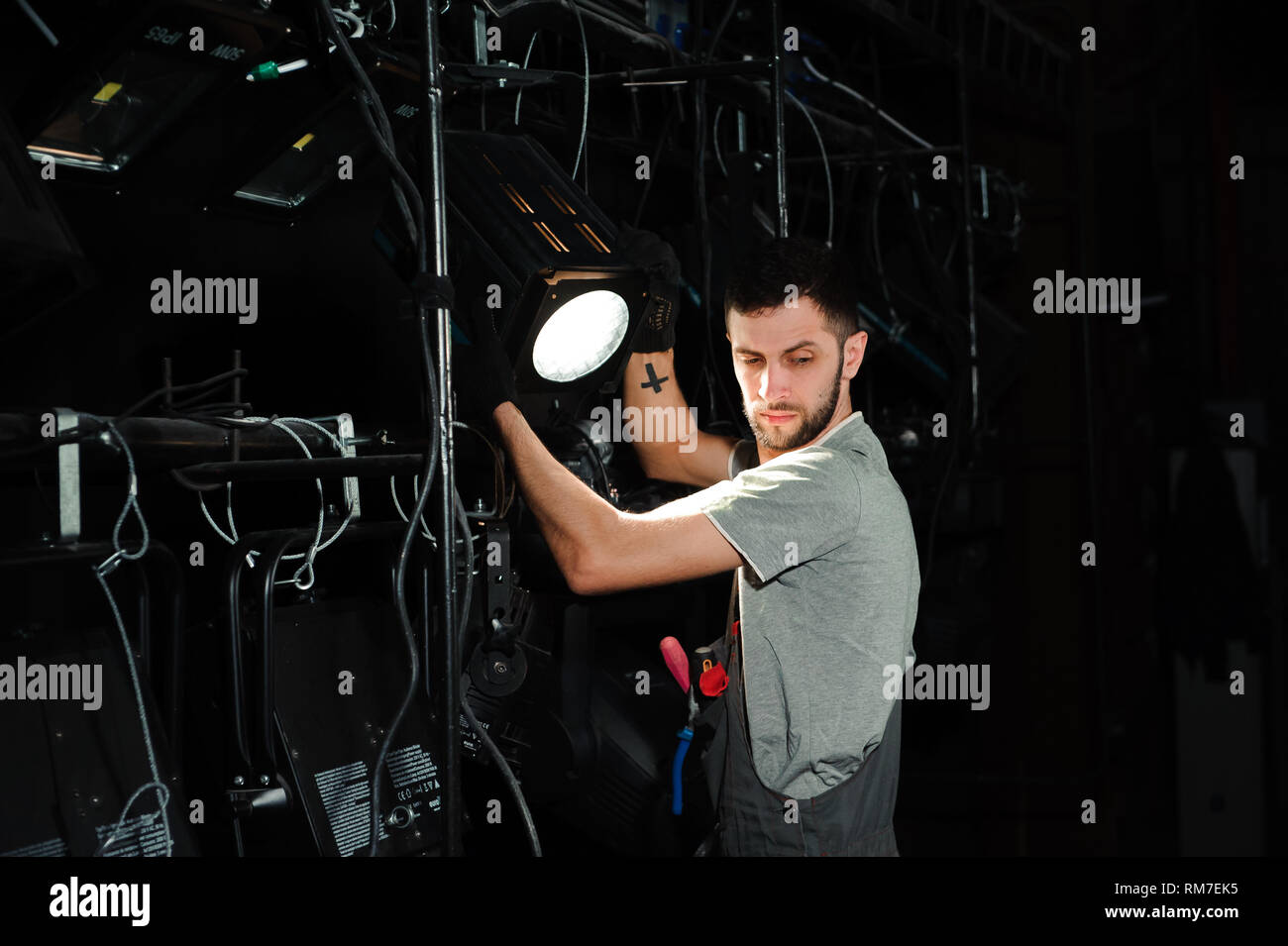 The stage worker sets up the lights on the stage Stock Photo - Alamy