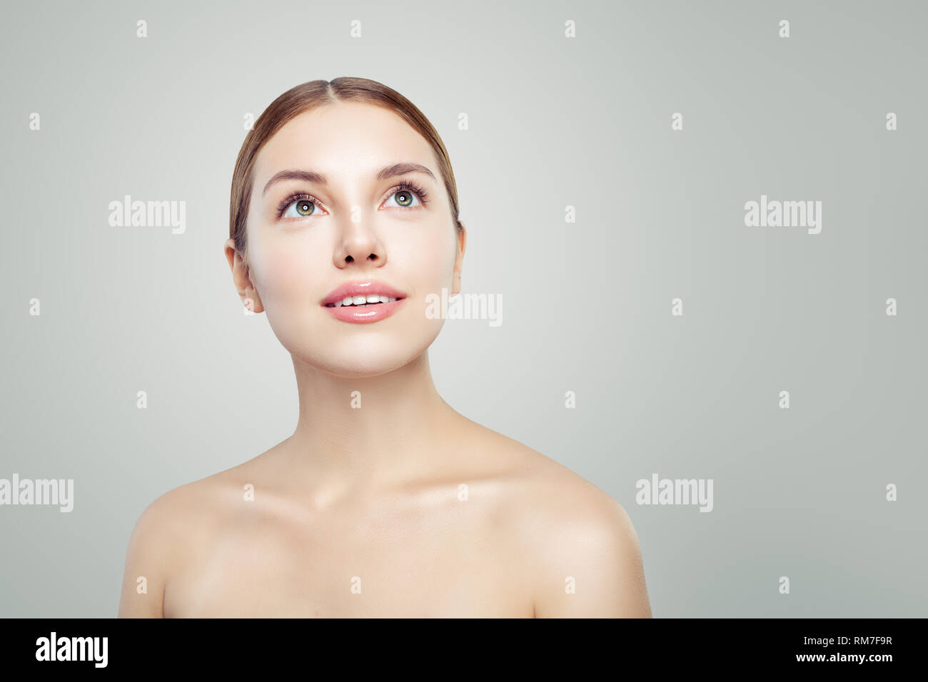 Healthy woman looking up. Young perfect model face with clear skin ...