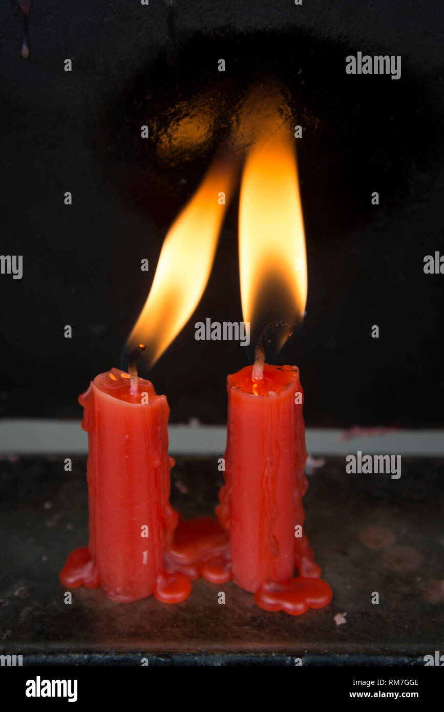 Red candles in a shrine Stock Photo - Alamy