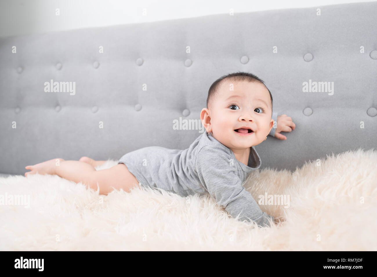 cute happy baby portrait lying on fur Stock Photo - Alamy