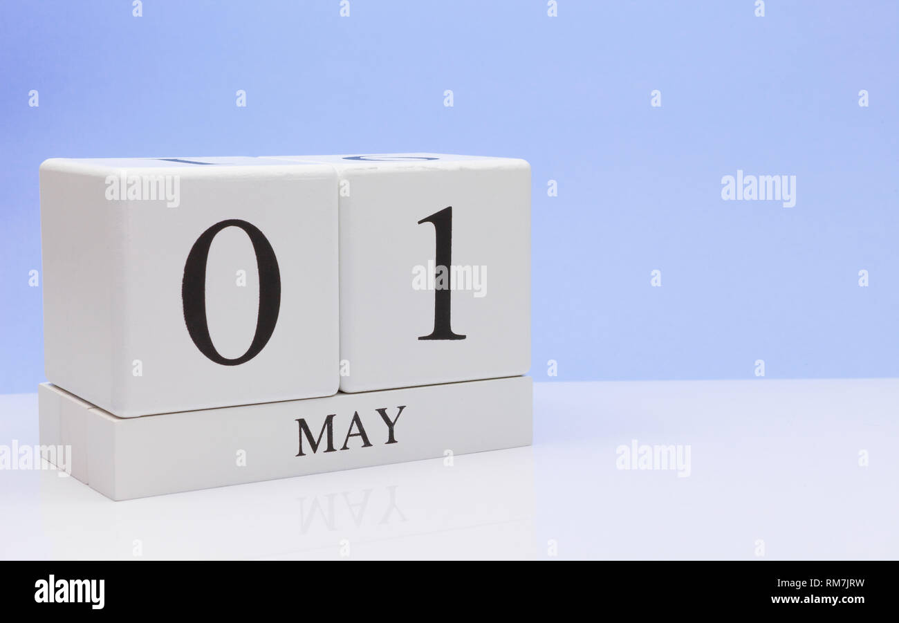May 01st. Day 1 of month, daily calendar on white table with reflection ...