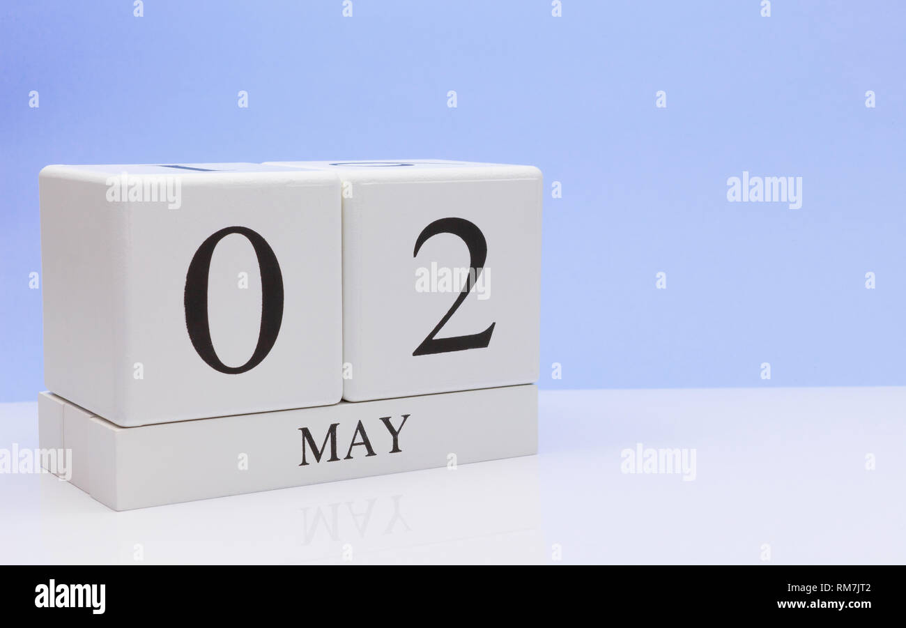 May 02st. Day 2 of month, daily calendar on white table with reflection ...