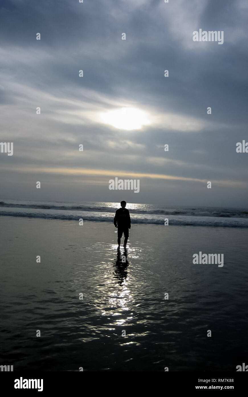 Silhouette of a man against the backdrop of the sea sunset Stock Photo ...