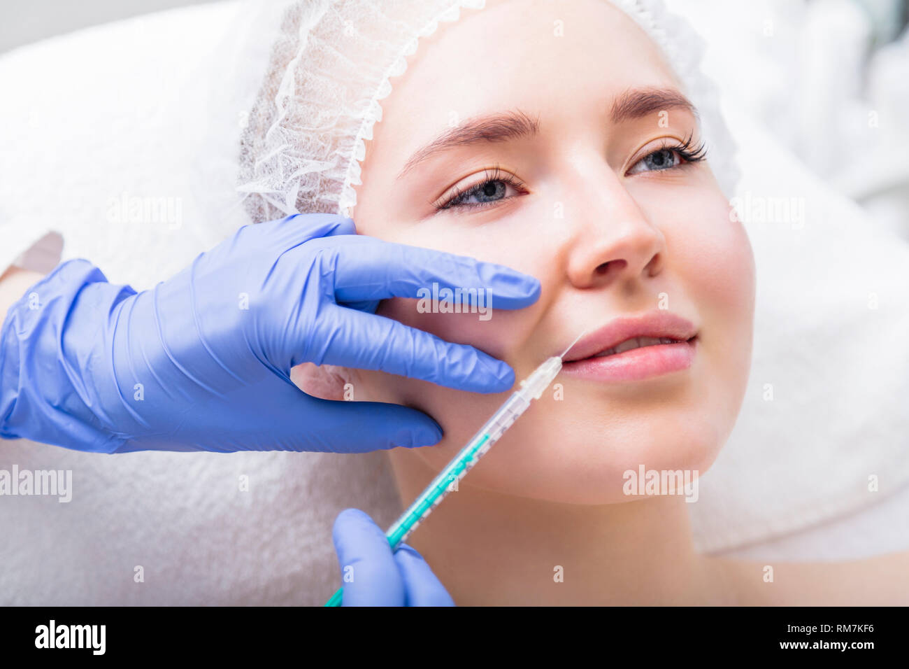Cosmetic beauty injection to beautiful woman face Stock Photo - Alamy