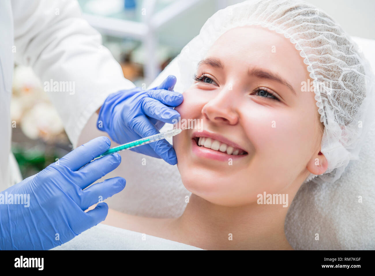 Cosmetic beauty injection to beautiful woman face Stock Photo - Alamy