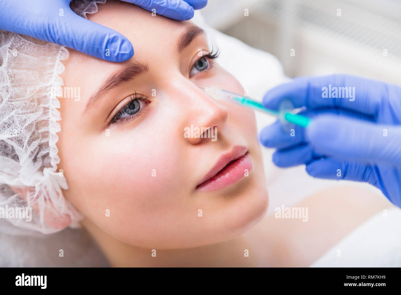 Woman receiving beauty plastic injection on her nose Stock Photo - Alamy