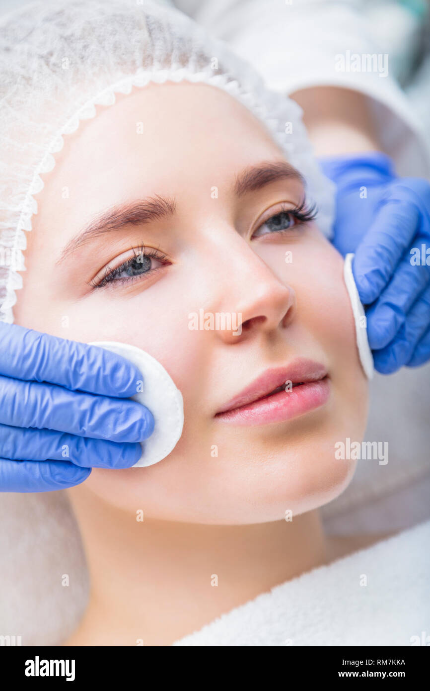 Young woman getting face procedure at salon Stock Photo - Alamy