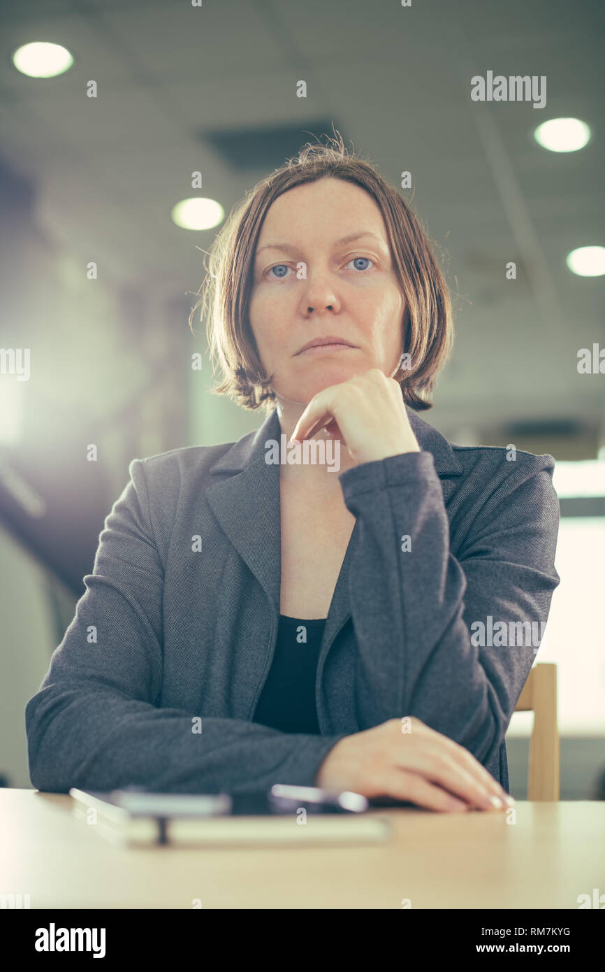 Portrait of confident female entrepreneur in office looking at camera ...