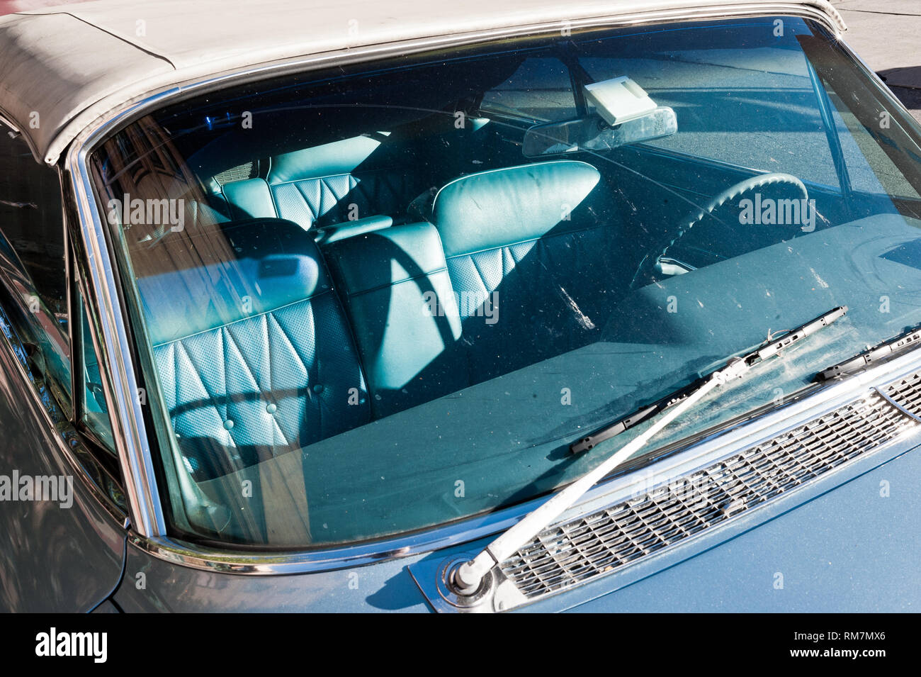 Classic Cadillac blue interior bathed in sunshine seen looking through ...