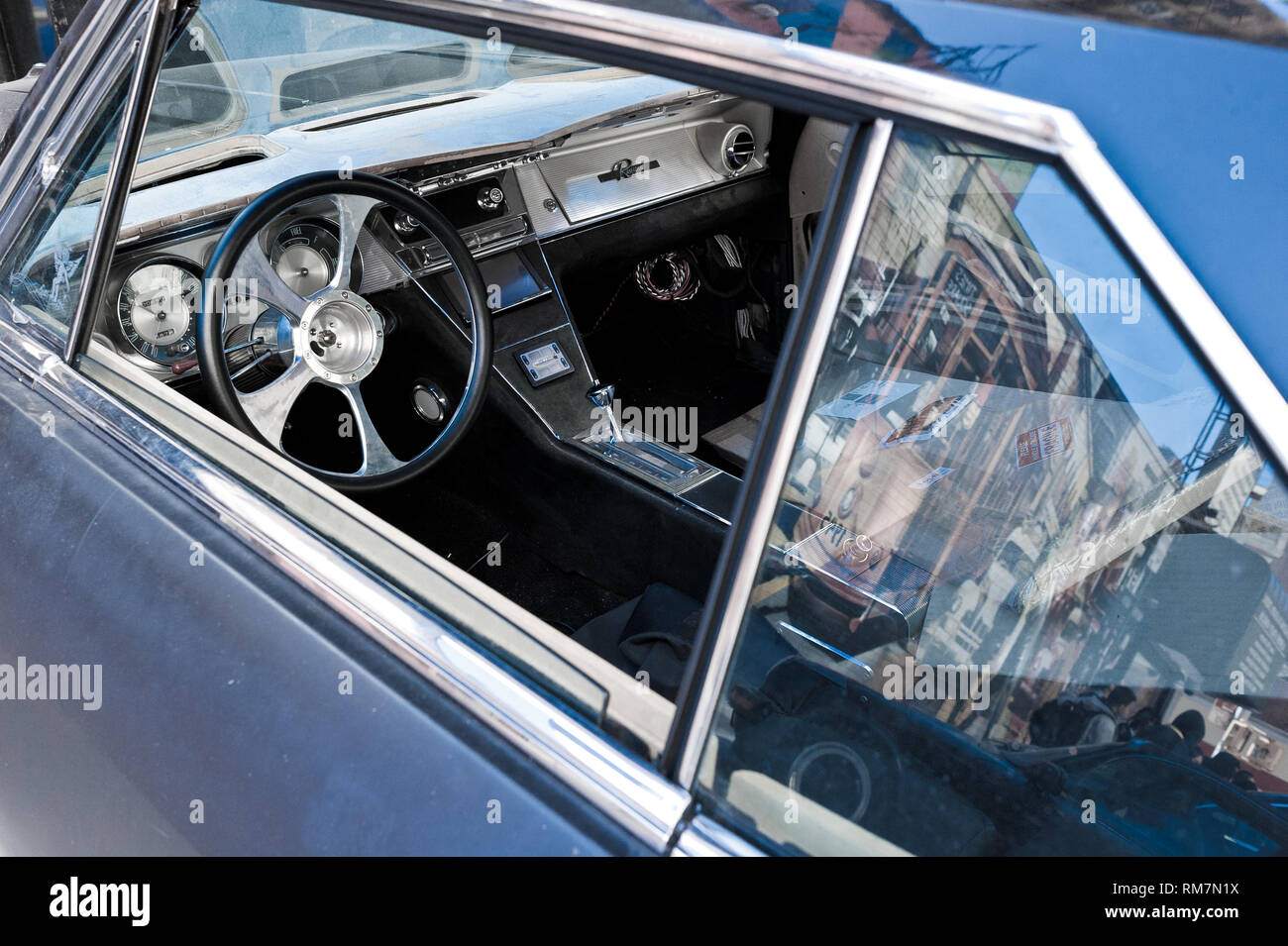 Looking in american muscle car side window which is down at sedan ...