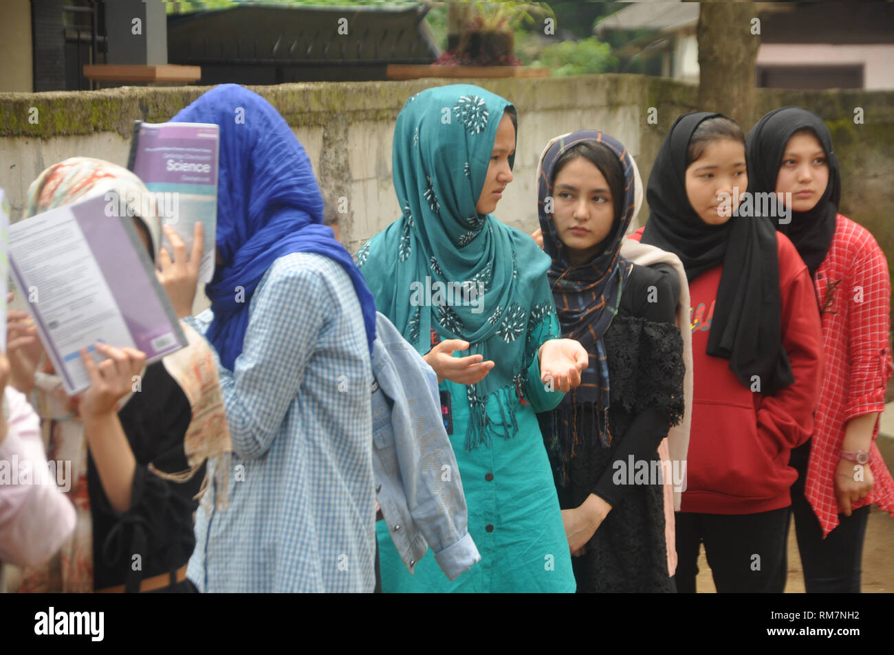 A number of immigrant children are seen walking into their classrooms ...