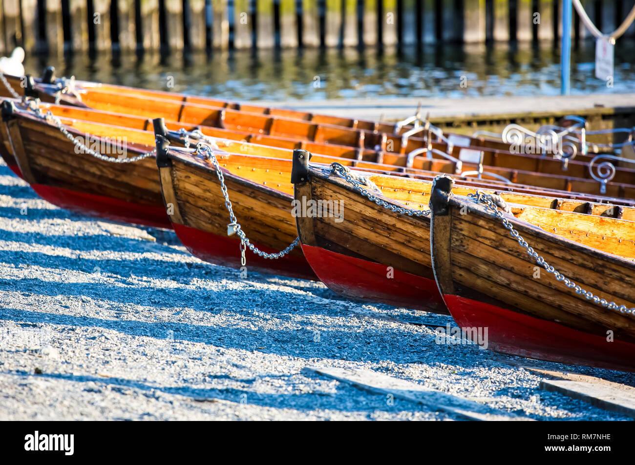 Wooden boats with chains standing on the beach in a row Stock Photo - Alamy