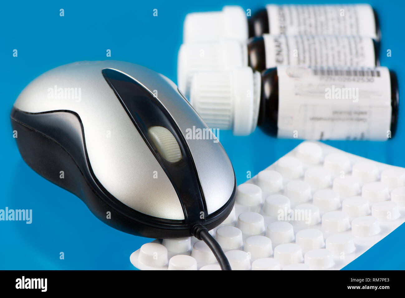 Mouse and pills as symbol for online ordering of medicine in an ...