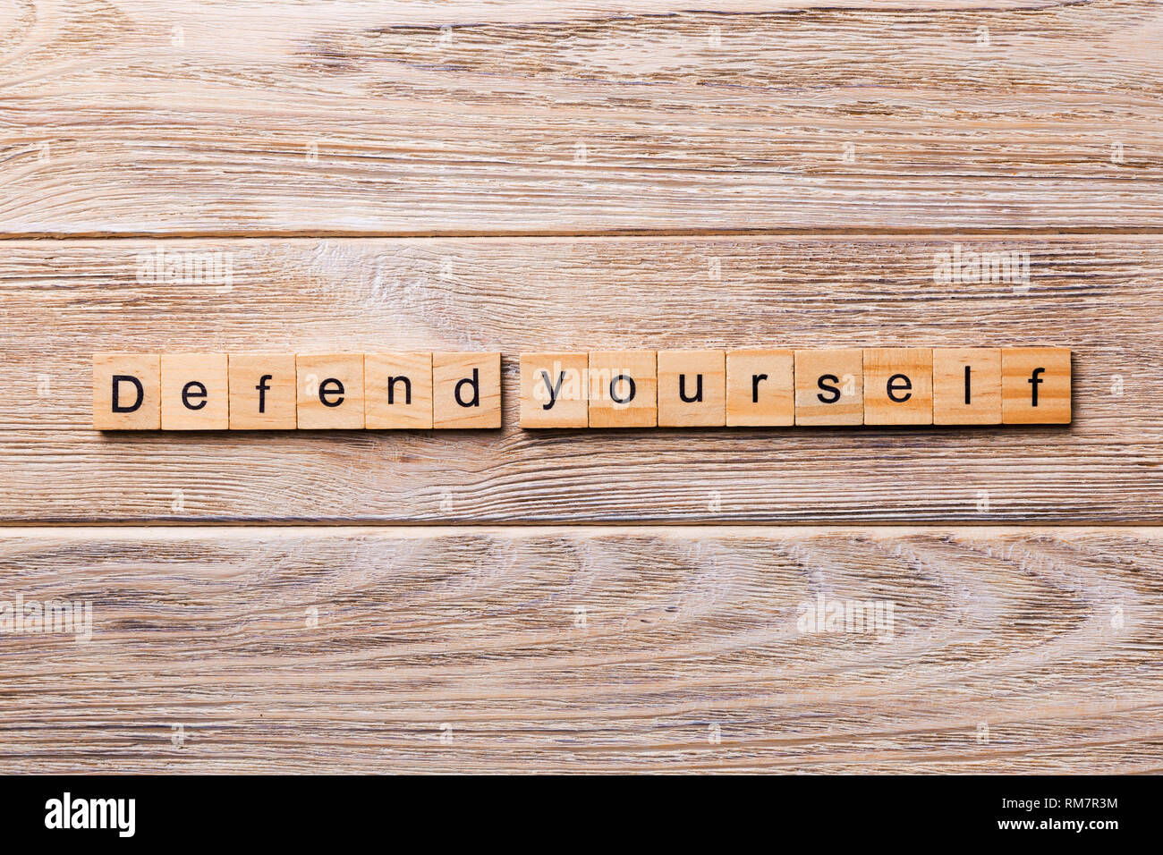defend yourself word written on wood block. defend yourself text on ... defend yourself word written on wood block. defend yourself text on ...