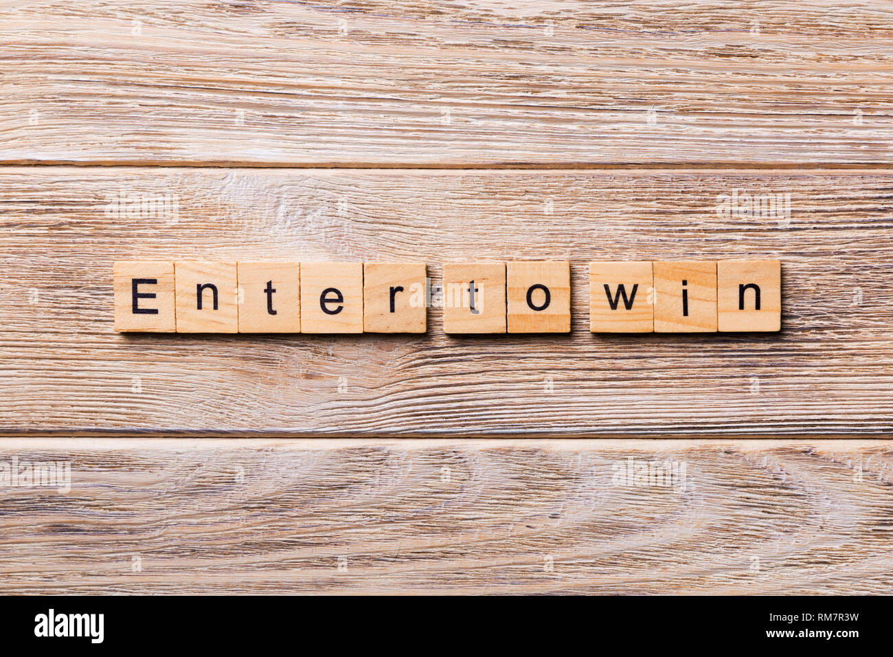 Enter To Win word written on wood block. Enter To Win text on wooden ...