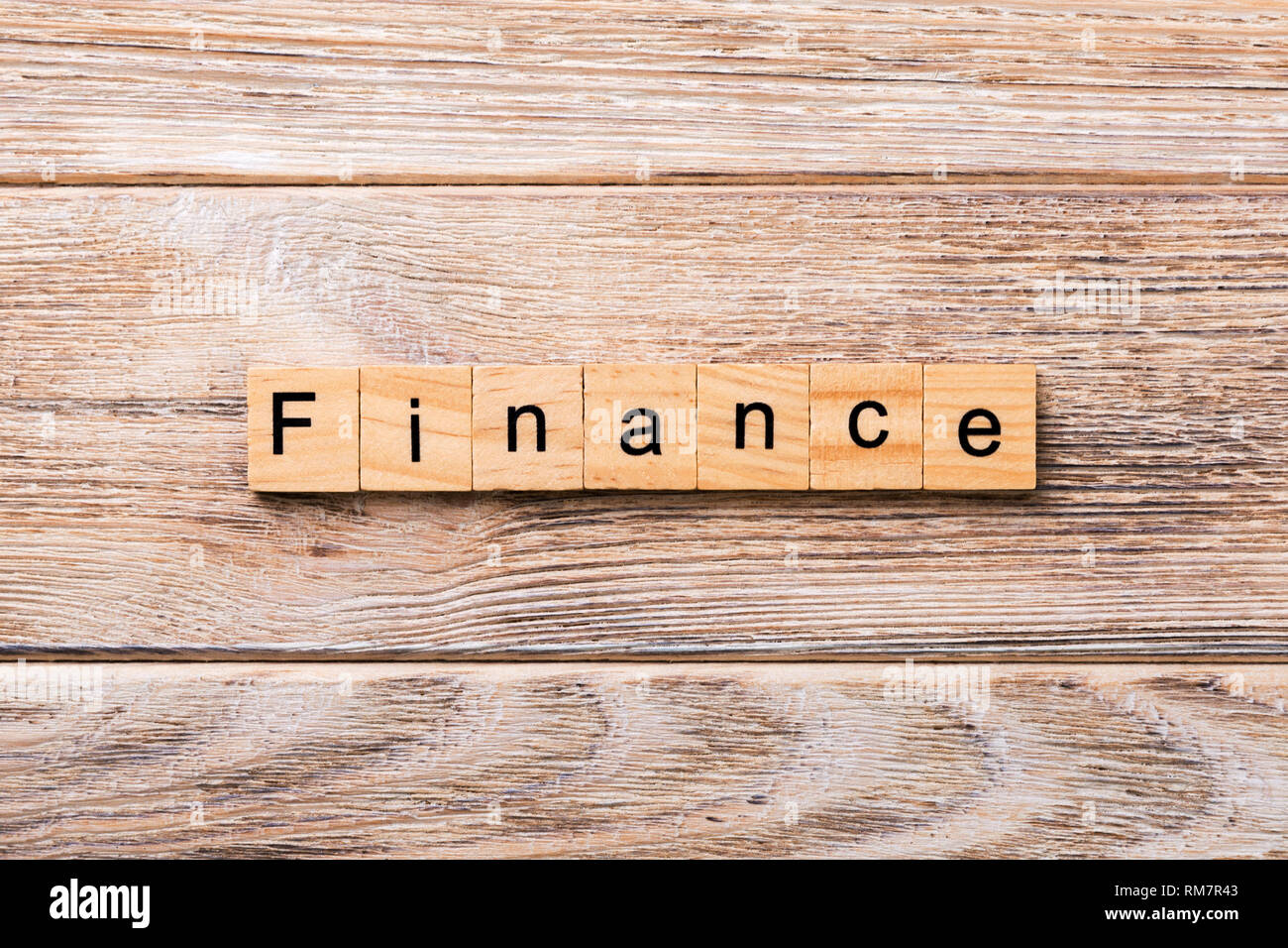 FINANCE word written on wood block. FINANCE text on wooden table for ...