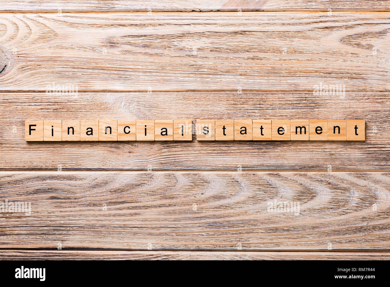 Financial statement word written on wood block. Financial statement ...