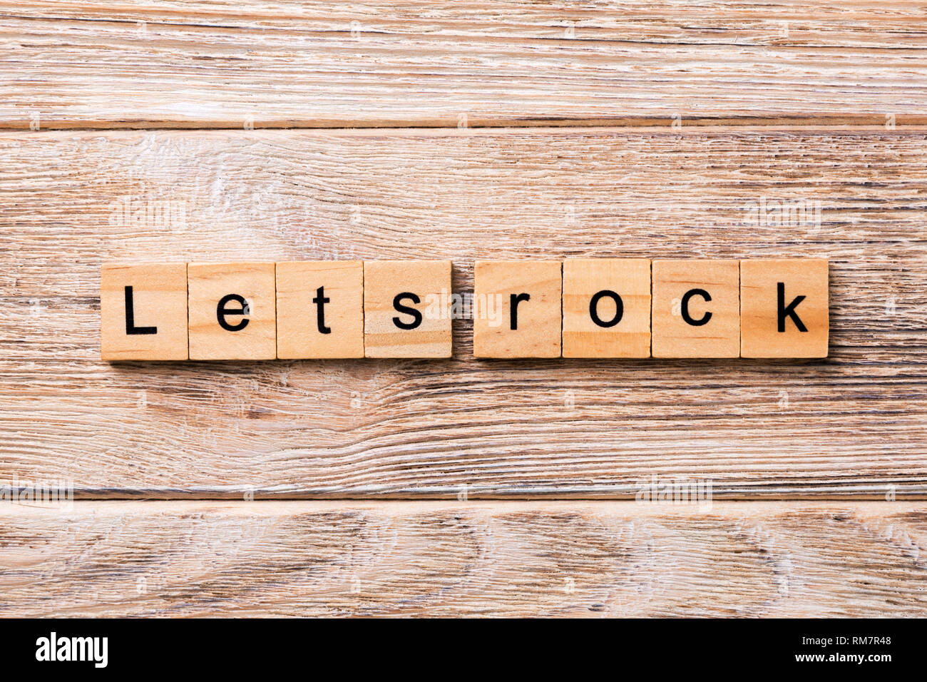 Let's Rock word written on wood block. Lets Rock text on wooden table ...