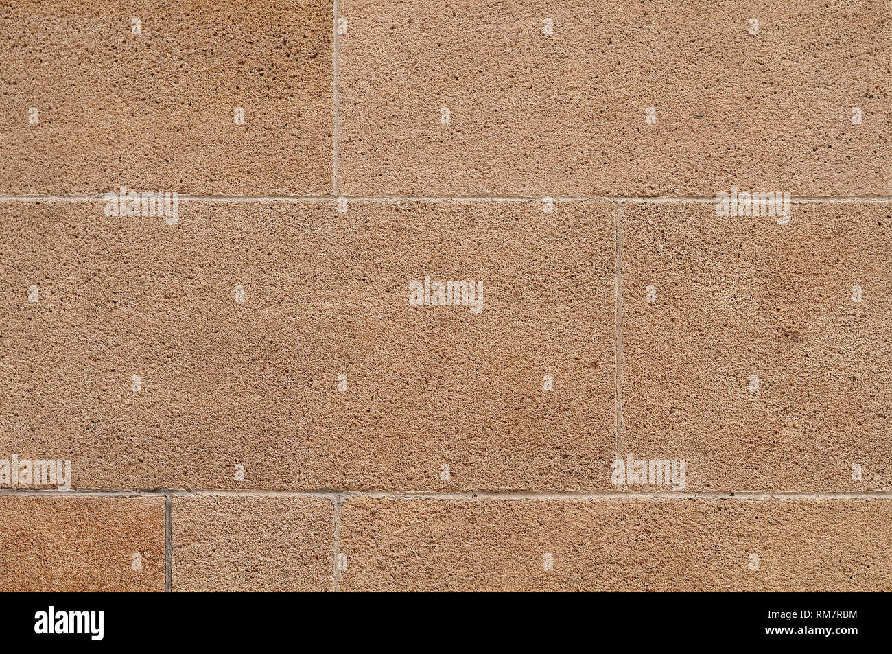 sandstone facade of a building constructed with large blocks and mortar ...
