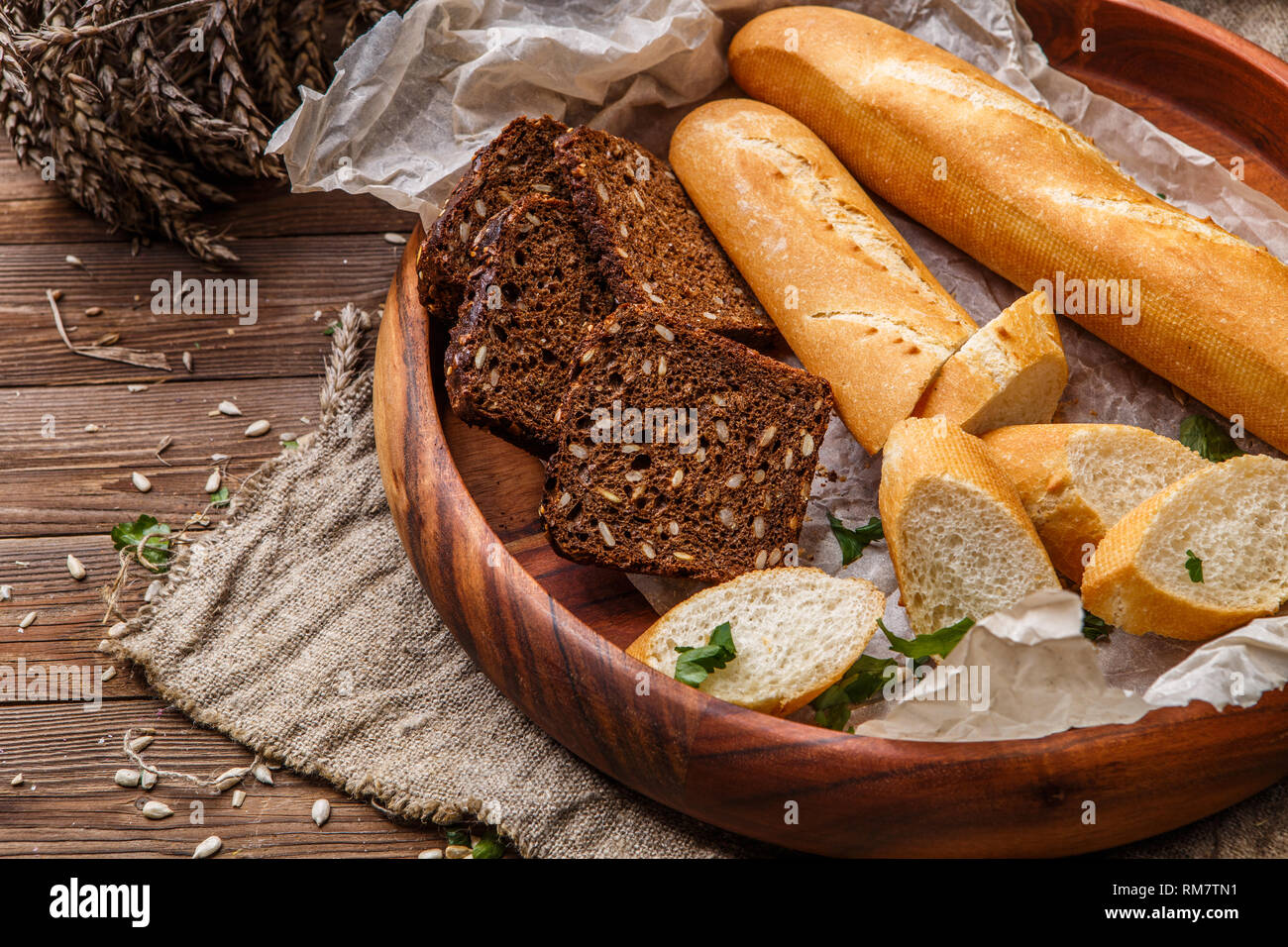 Loaf, bread in wooden saucer Stock Photo - Alamy