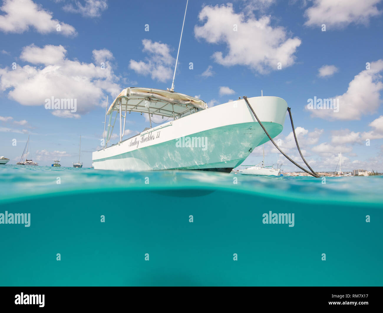 A moored boat bobbing up and down in Carlisle bay, Barbados Stock Photo ...