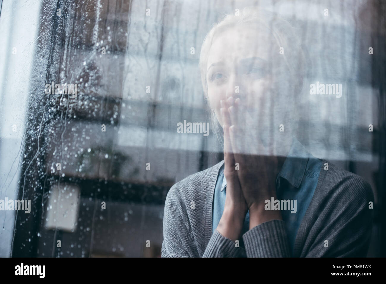 Woman crying window hi-res stock photography and images - Alamy