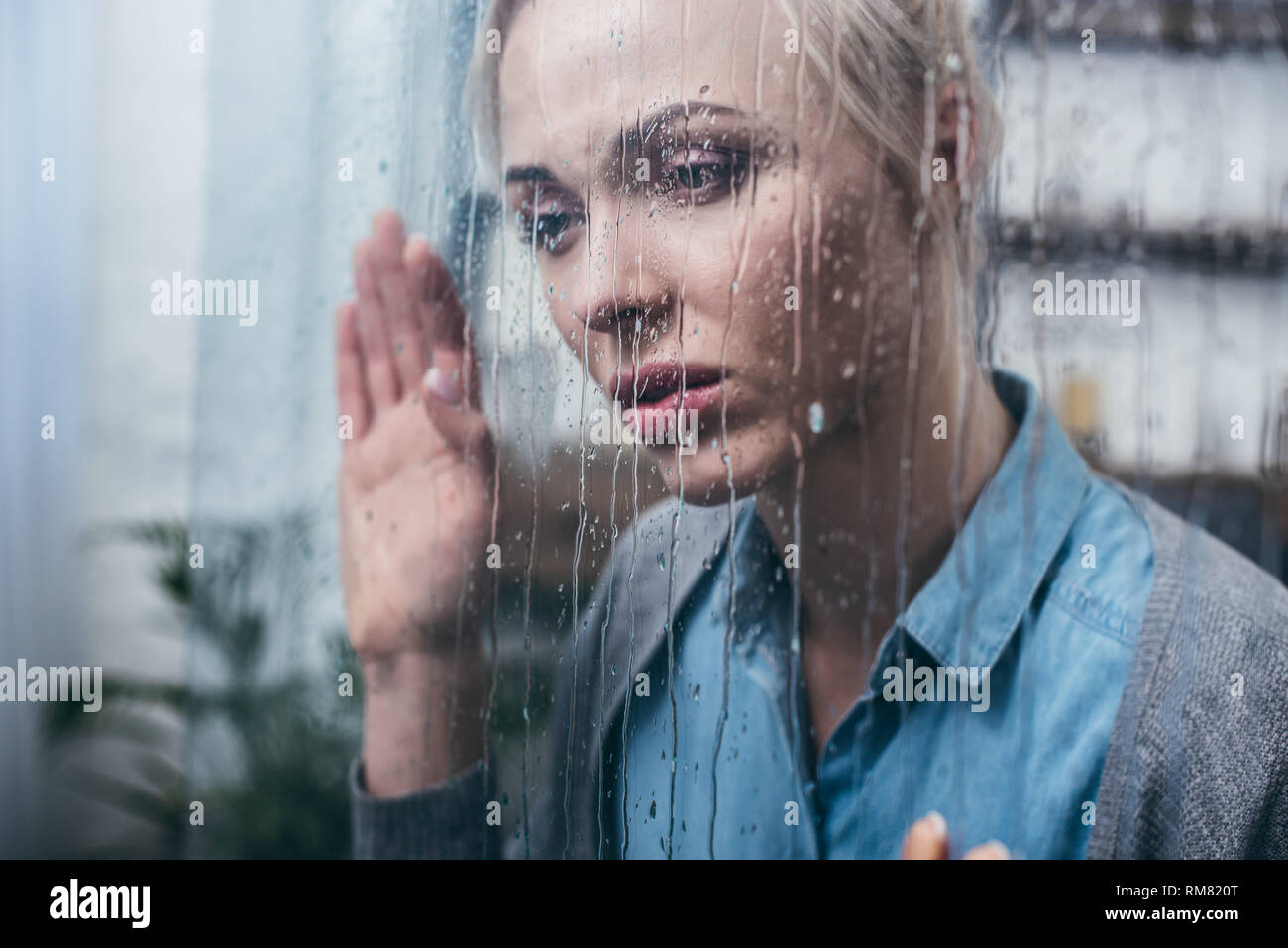 depressed adult woman touching window with raindrops Stock Photo - Alamy