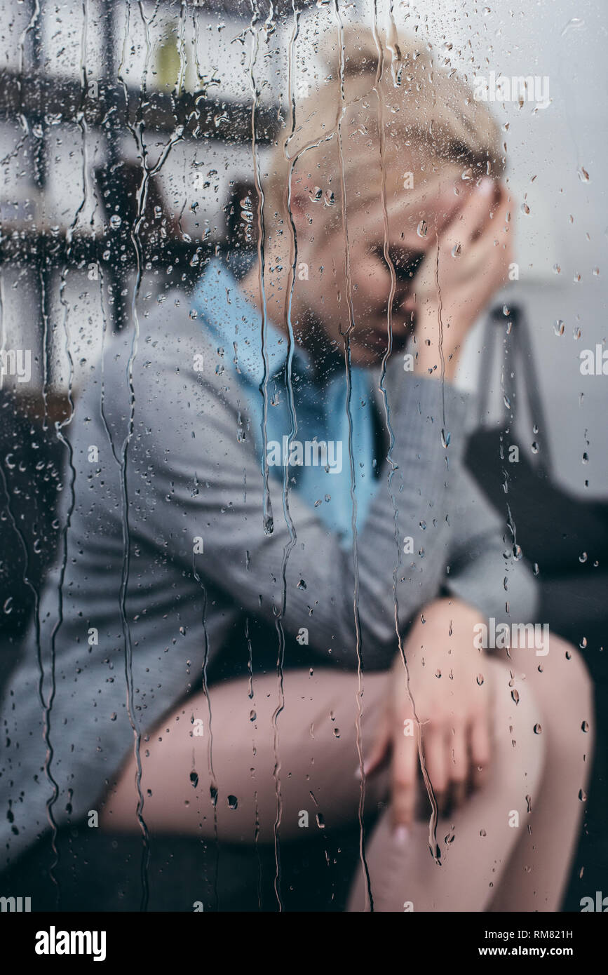 Sad woman touching window hi-res stock photography and images - Alamy
