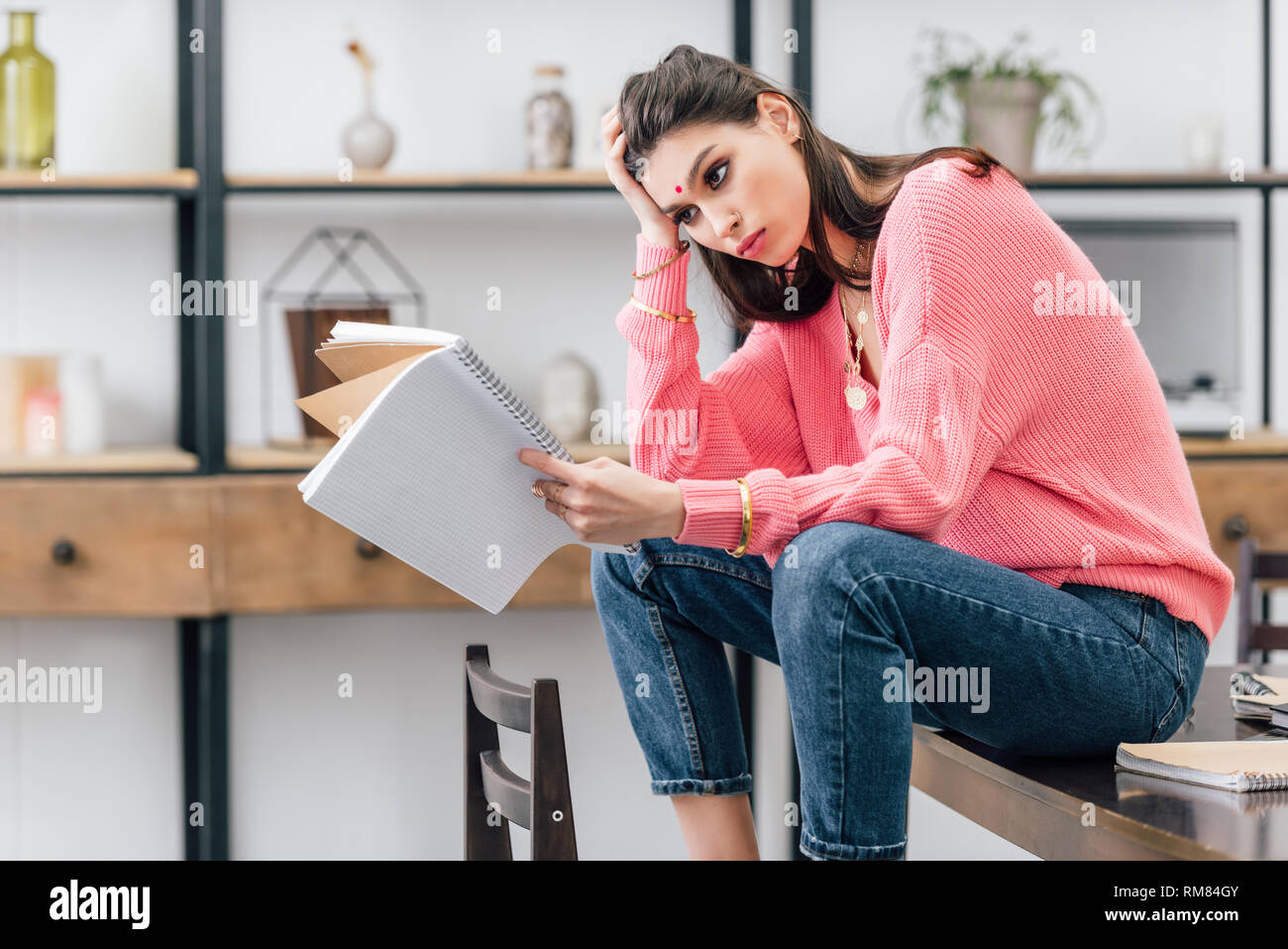 tired indian student with bindi studying with notebook at home Stock ...