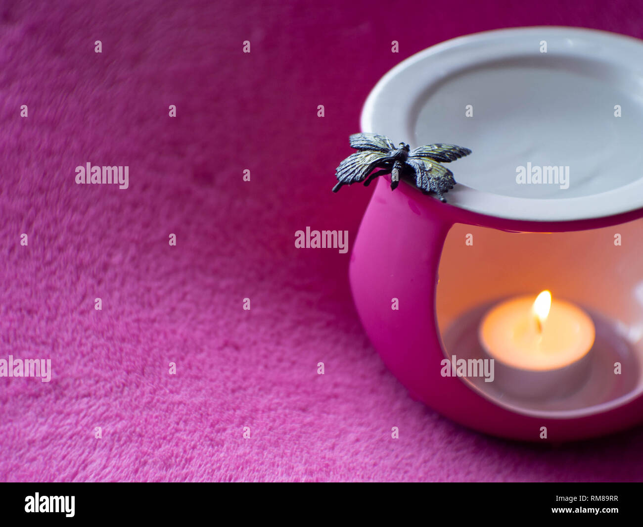 pink aromatherapy oil burners with candle, decorated with butterfly ...