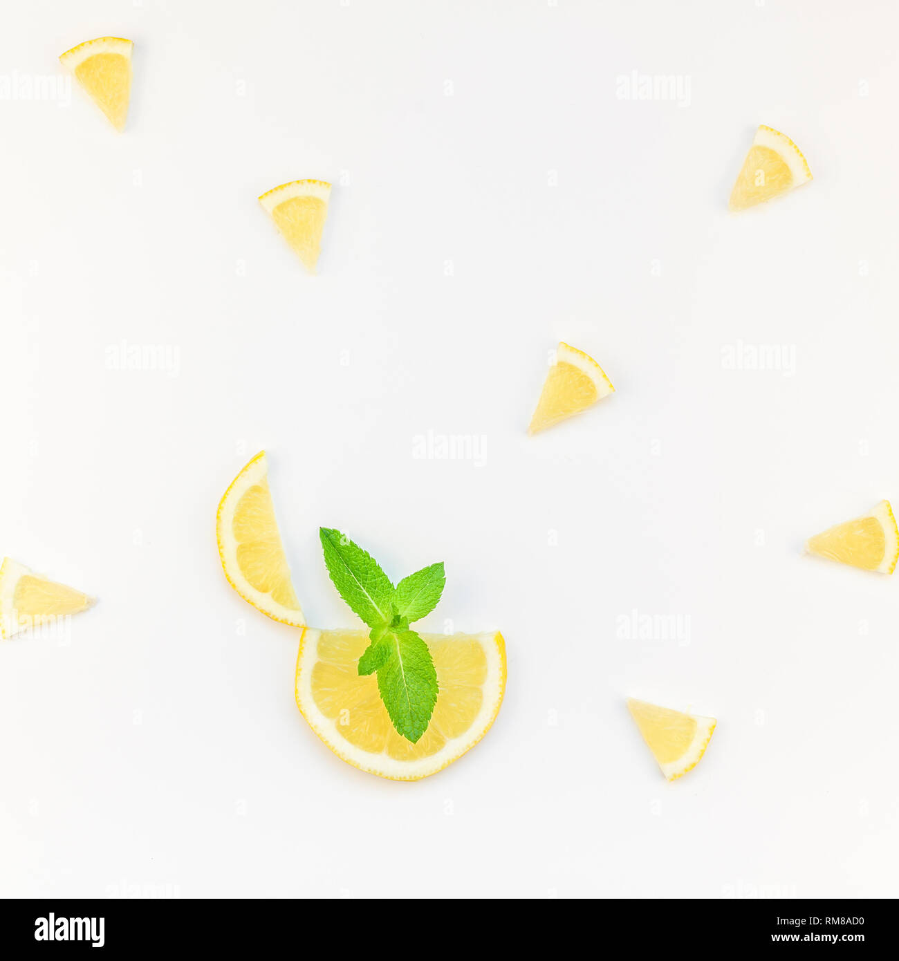 Square flatlay overhead top view citrus lemon slices and mint herbs leaves white table ...
