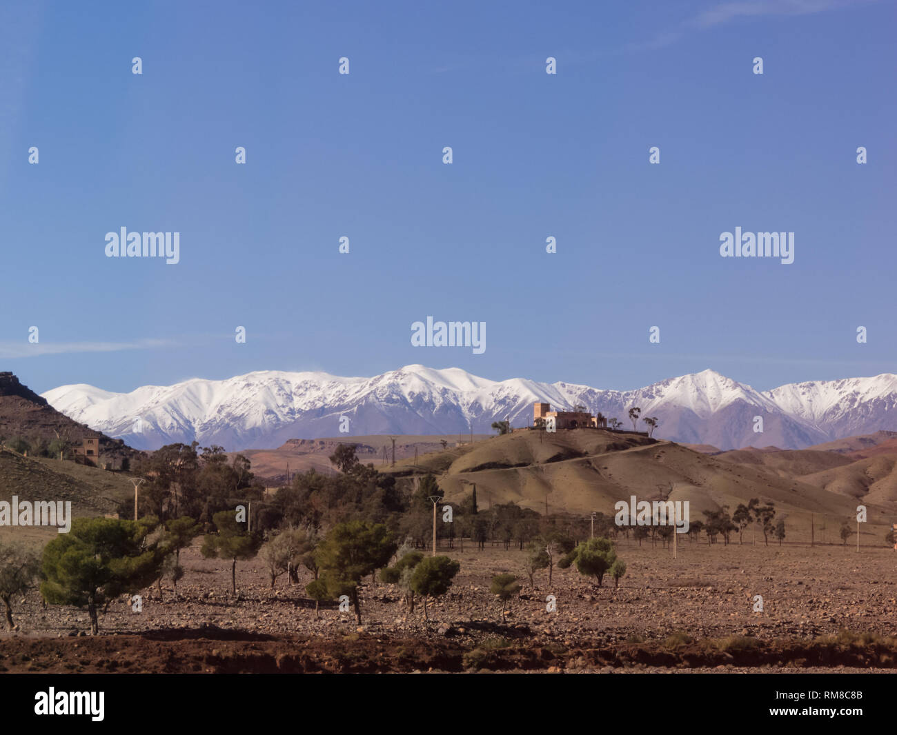 Sand hills below the snow covered Atlas mountains in Morocco Stock ...
