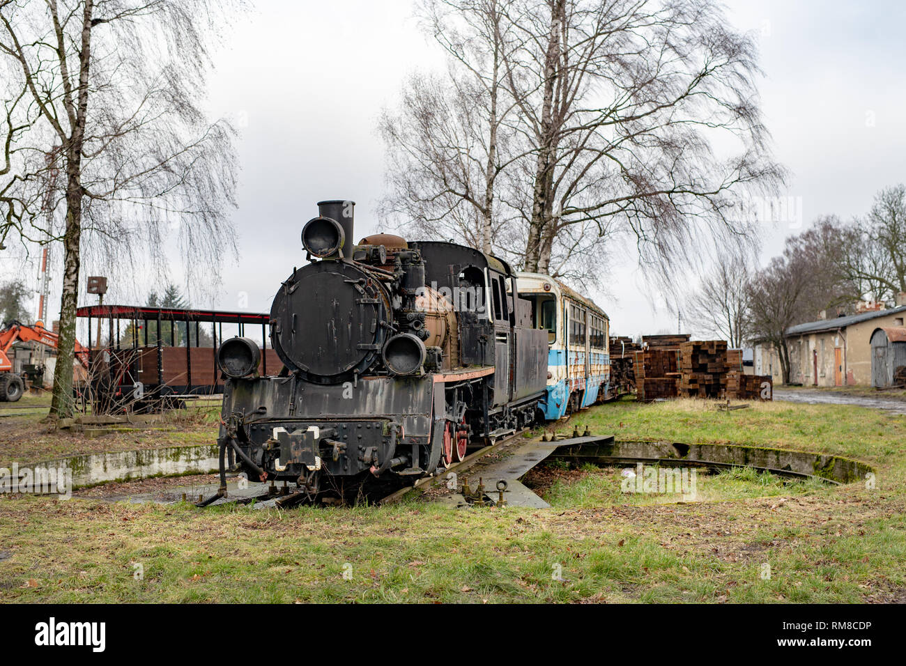 Old rusty locomotive of the narrow gauge railway. Place of stationing ...