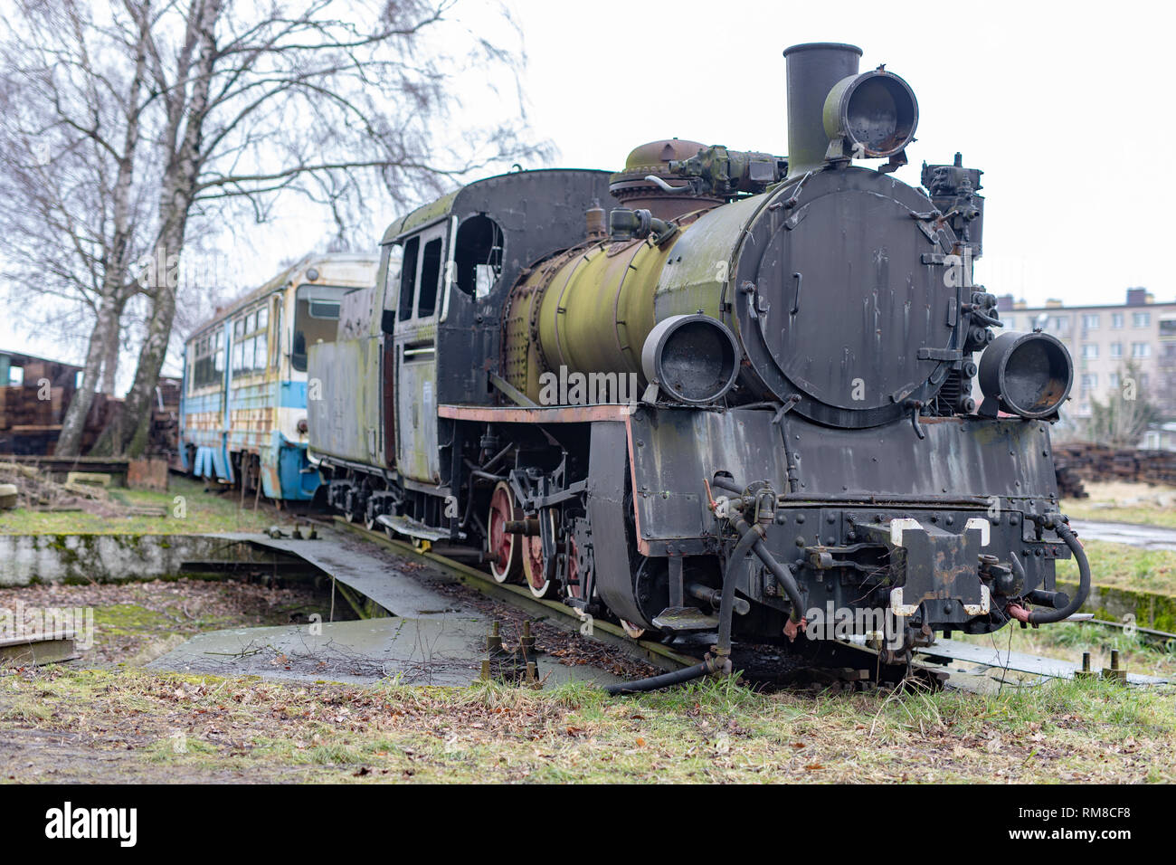 Old rusty locomotive of the narrow gauge railway. Place of stationing ...