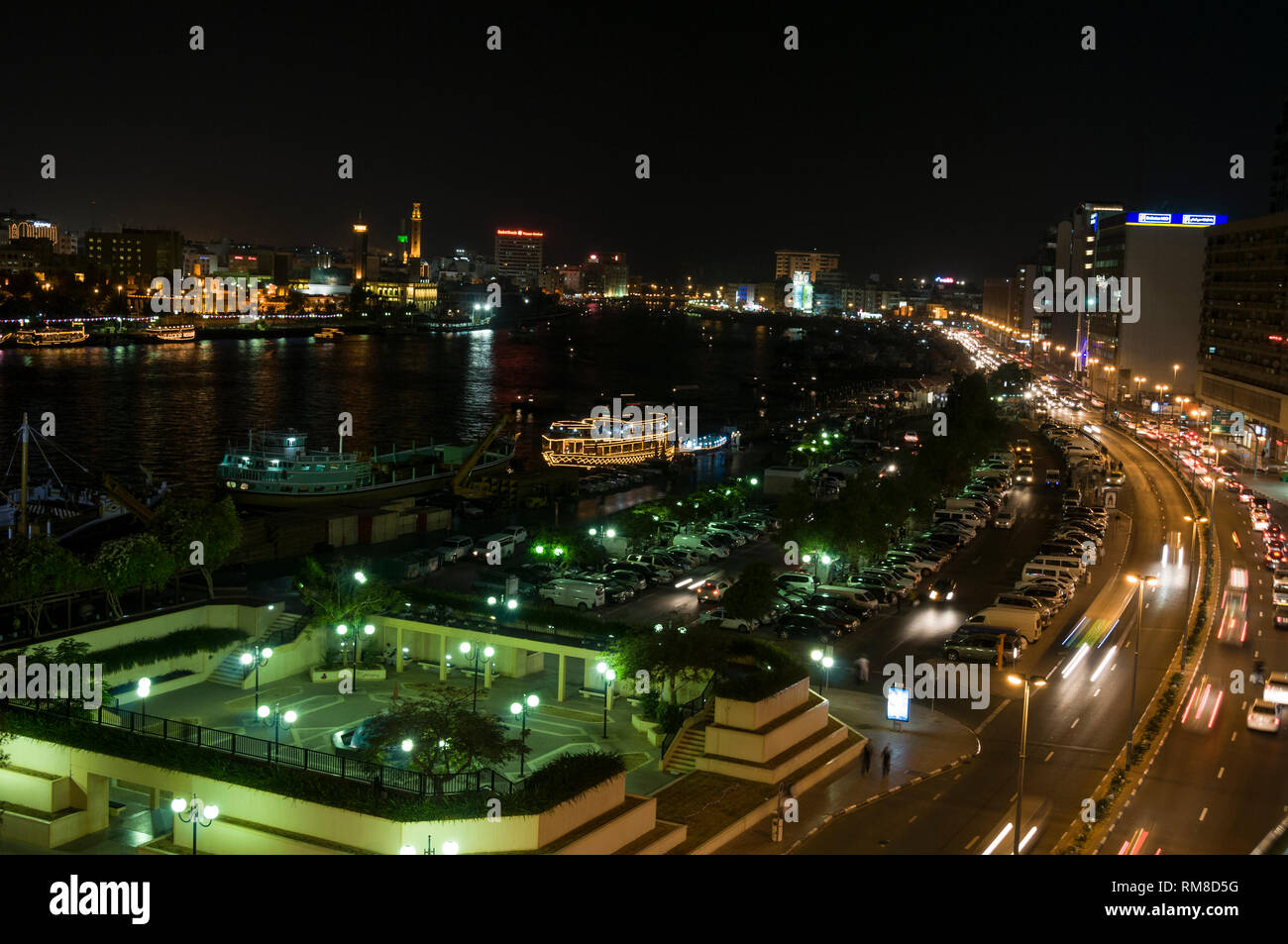 A lit up Dhow (Arab boat) converted as a floating restaurant moored ...
