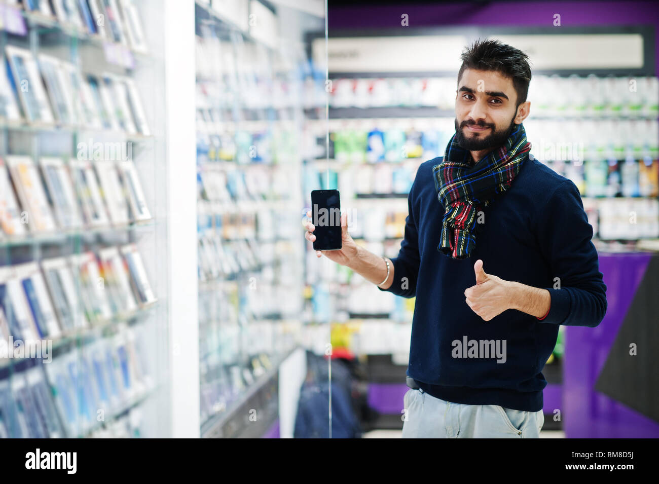 Indian beard man customer buyer at mobile phone store choose his new ...