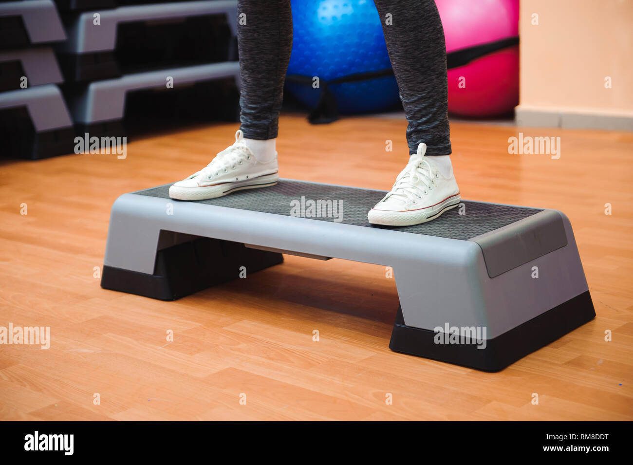 Athletic woman trainer doing aerobic class with steppers. Sport and ...