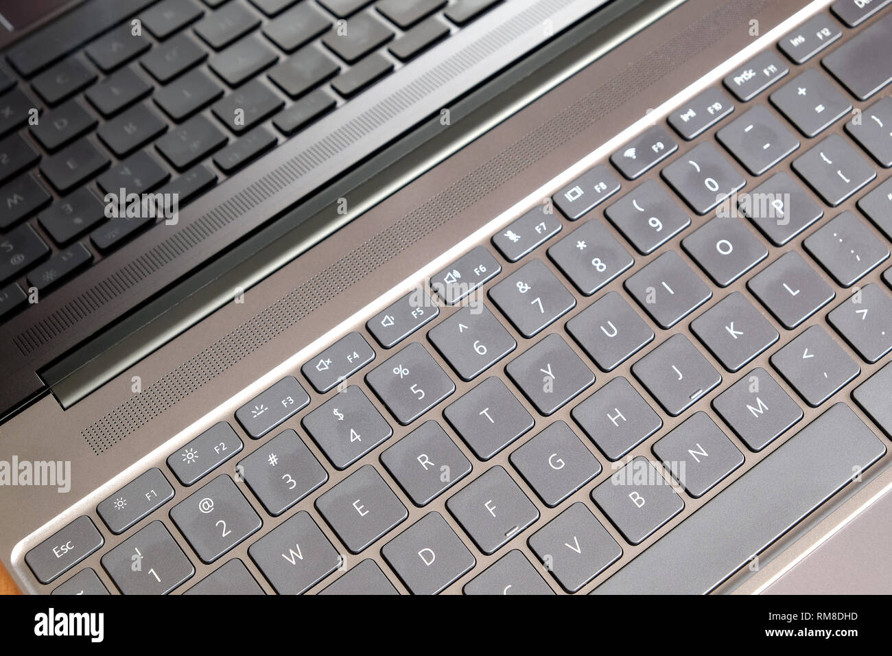 Part of opened laptop with keyboard, touchpad and empty mirror screen ...