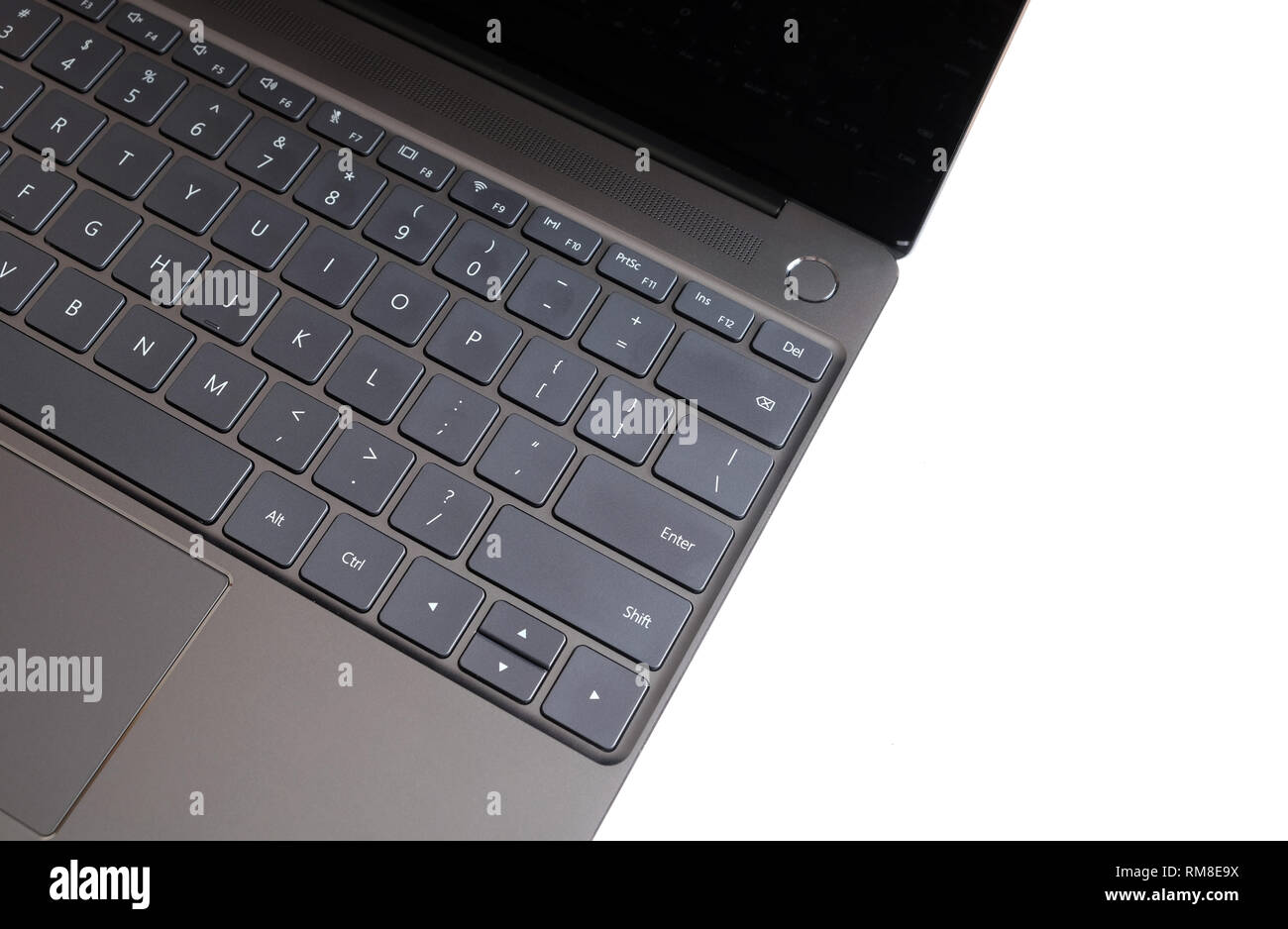 Part of opened laptop with keyboard, touchpad and empty mirror screen ...